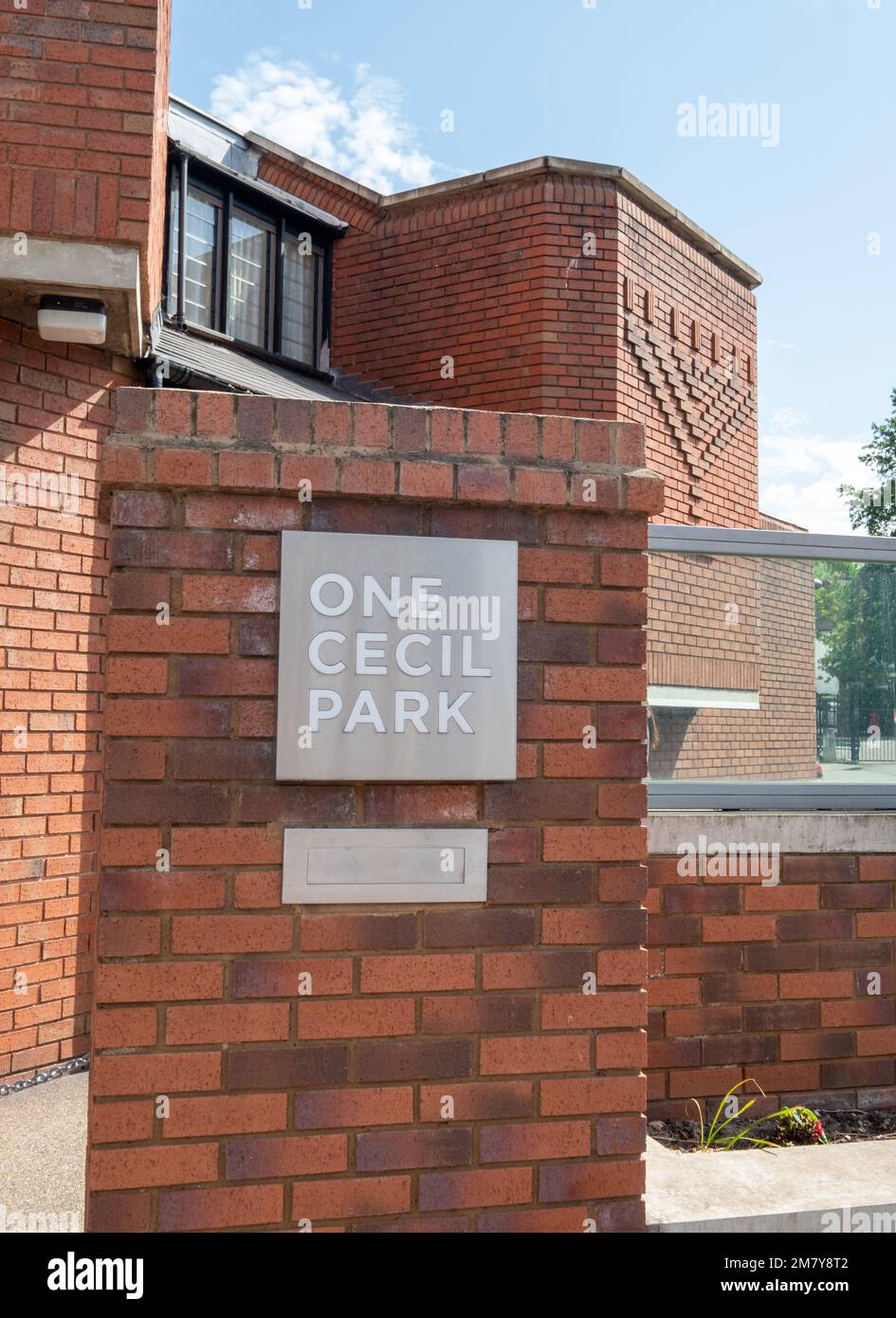 Pinner Synagogue in Cecil Park, built in red brick, with menorah icon ...