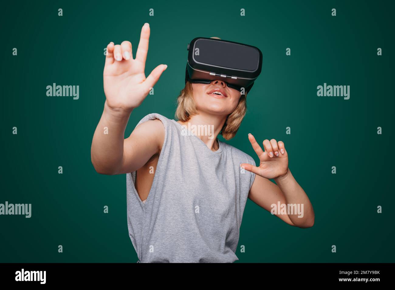 Gamer female student in VR headset exploring educational videogame and ...