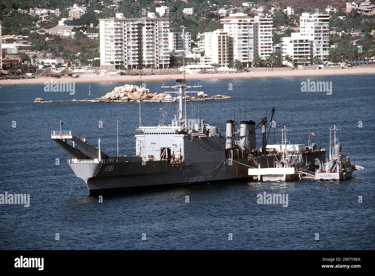 An elevated view of the tank landing ship USS RACINE (LST 1191), left ...