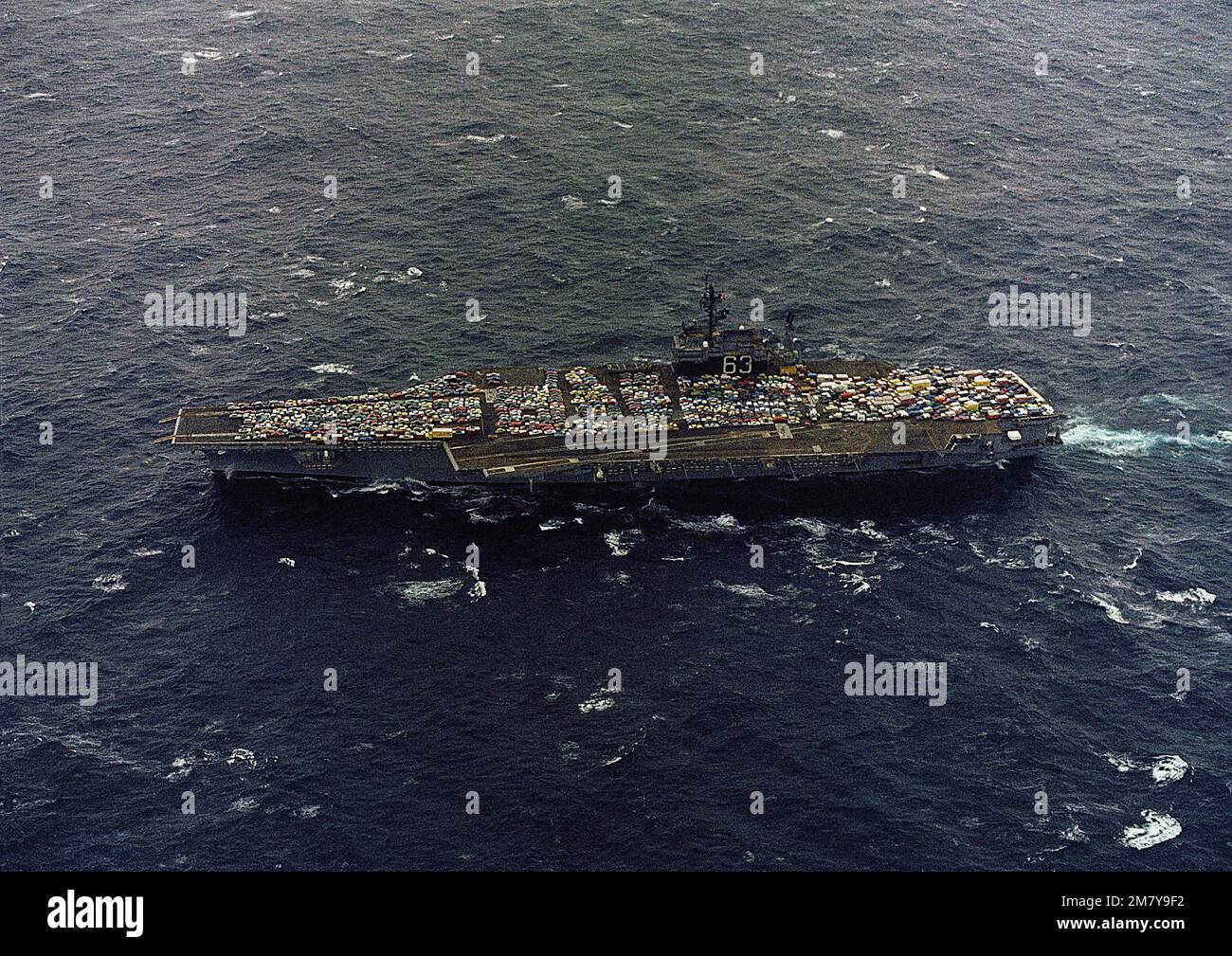 An aerial port beam view of the aircraft carrier USS KITTY HAWK (CV 63 ...