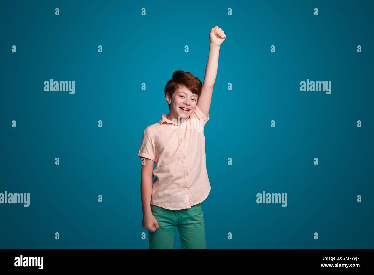 Children kid with happy expression hand up isolated on blue background ...