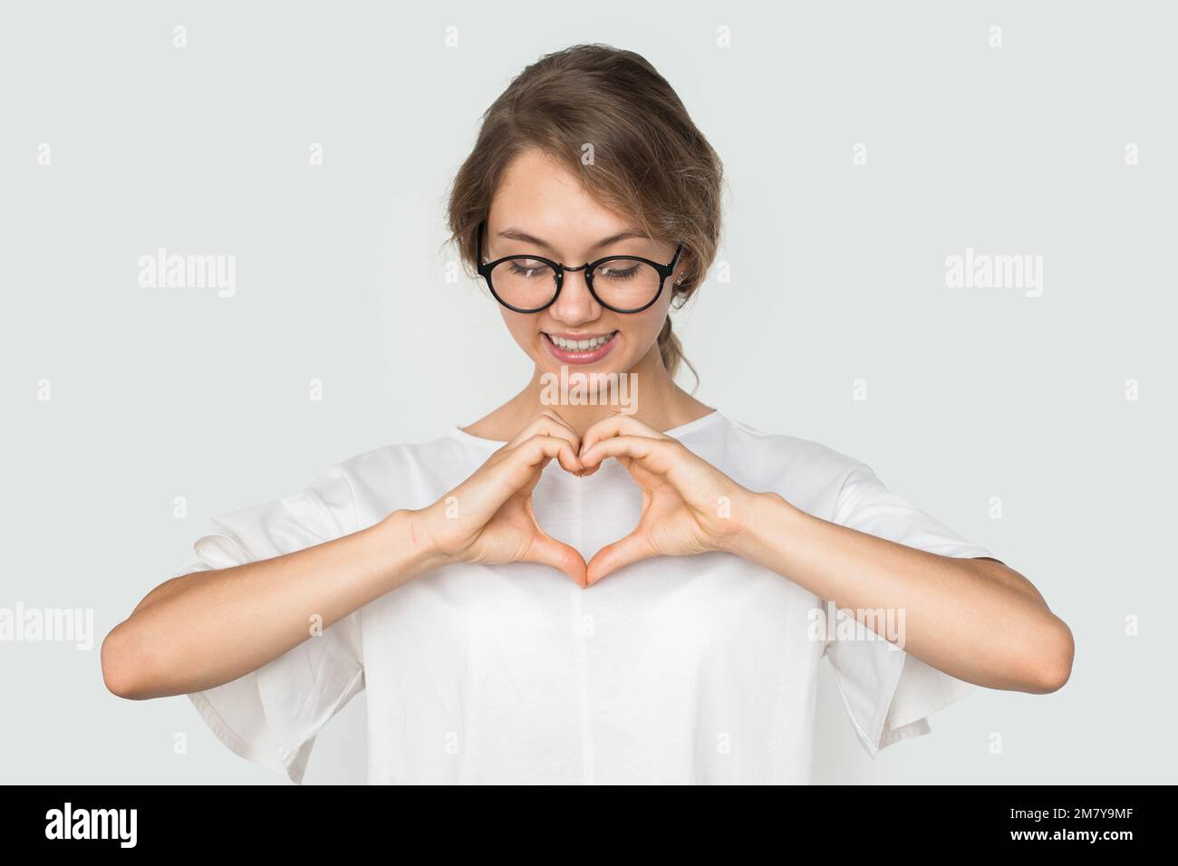 Pretty woman confessingg in love, making heart gesture, happy ...