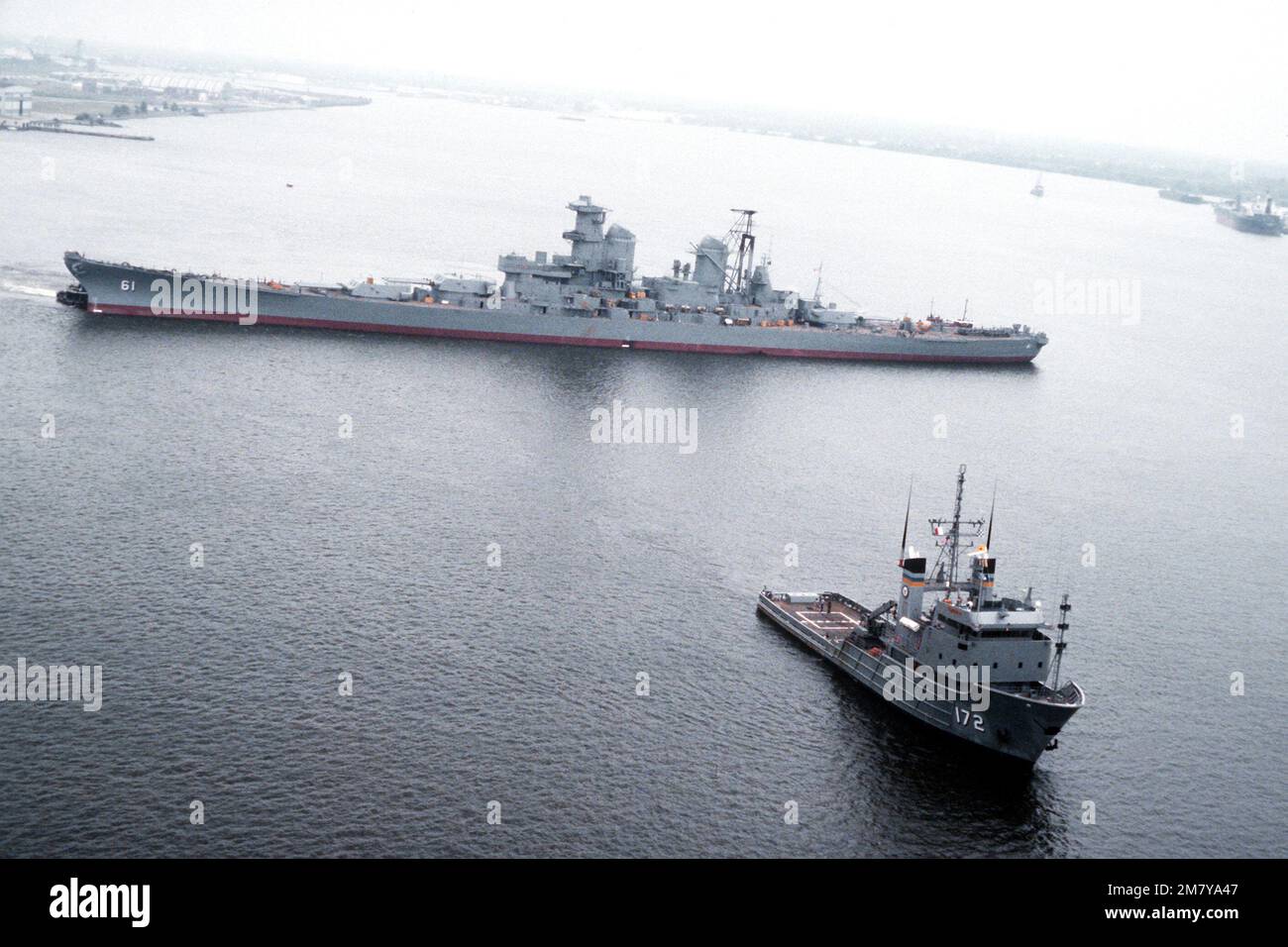 Aerial port beam view of the battleship IOWA (BB-61), as preparations ...