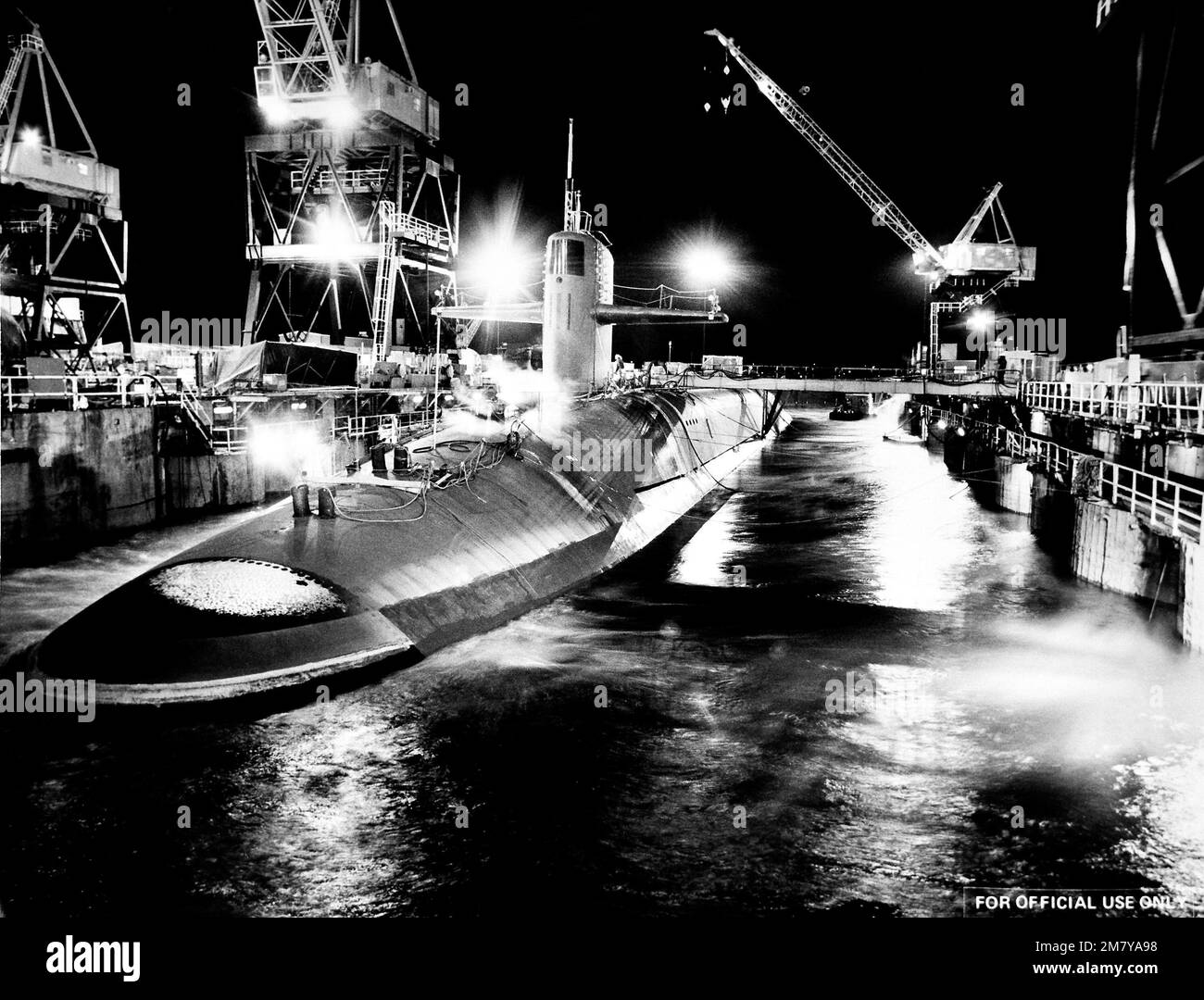 A nighttime port bow view of the nuclear-powered ballistic missile ...
