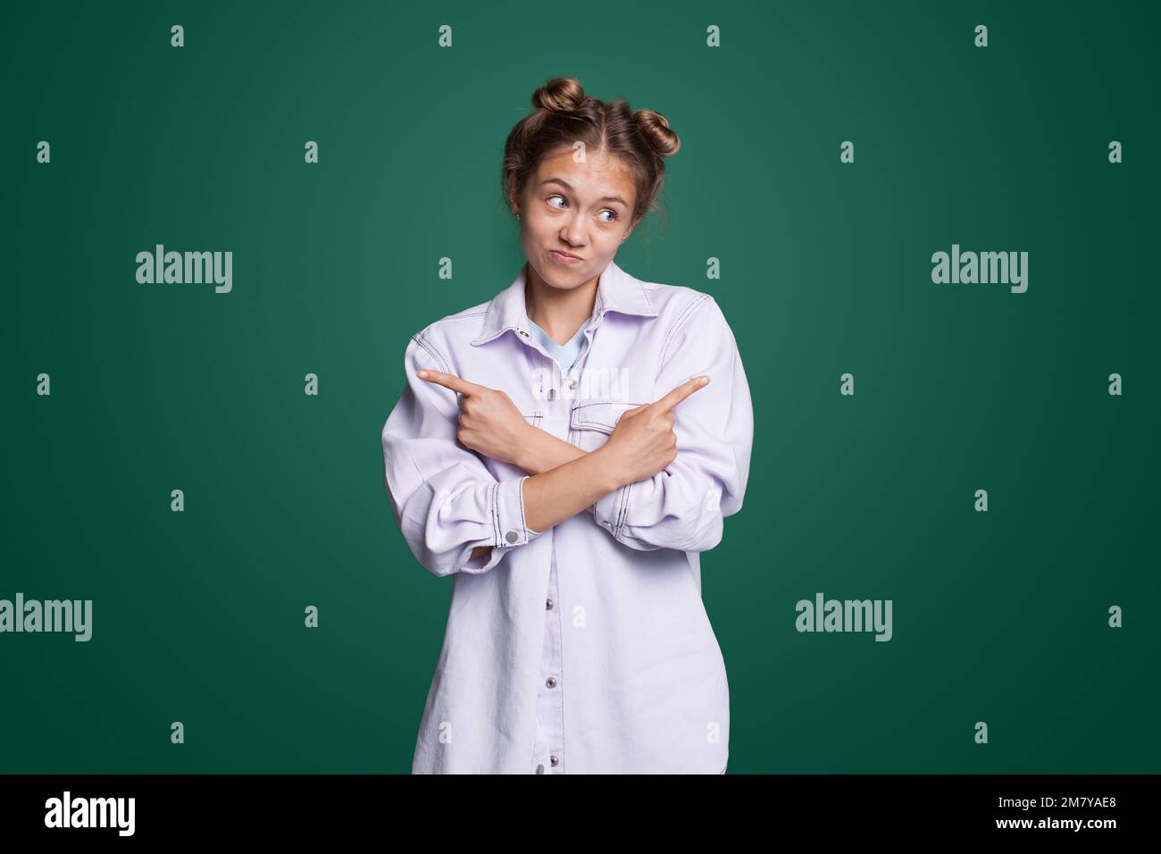 Thoughtful questioned attractive woman crossing hands against chest ...