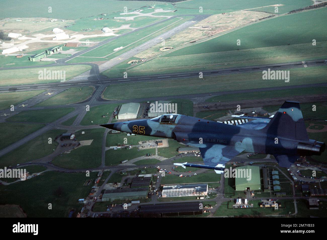 An air-to-air left side view of an F-5 Tiger II aircraft flown by the ...