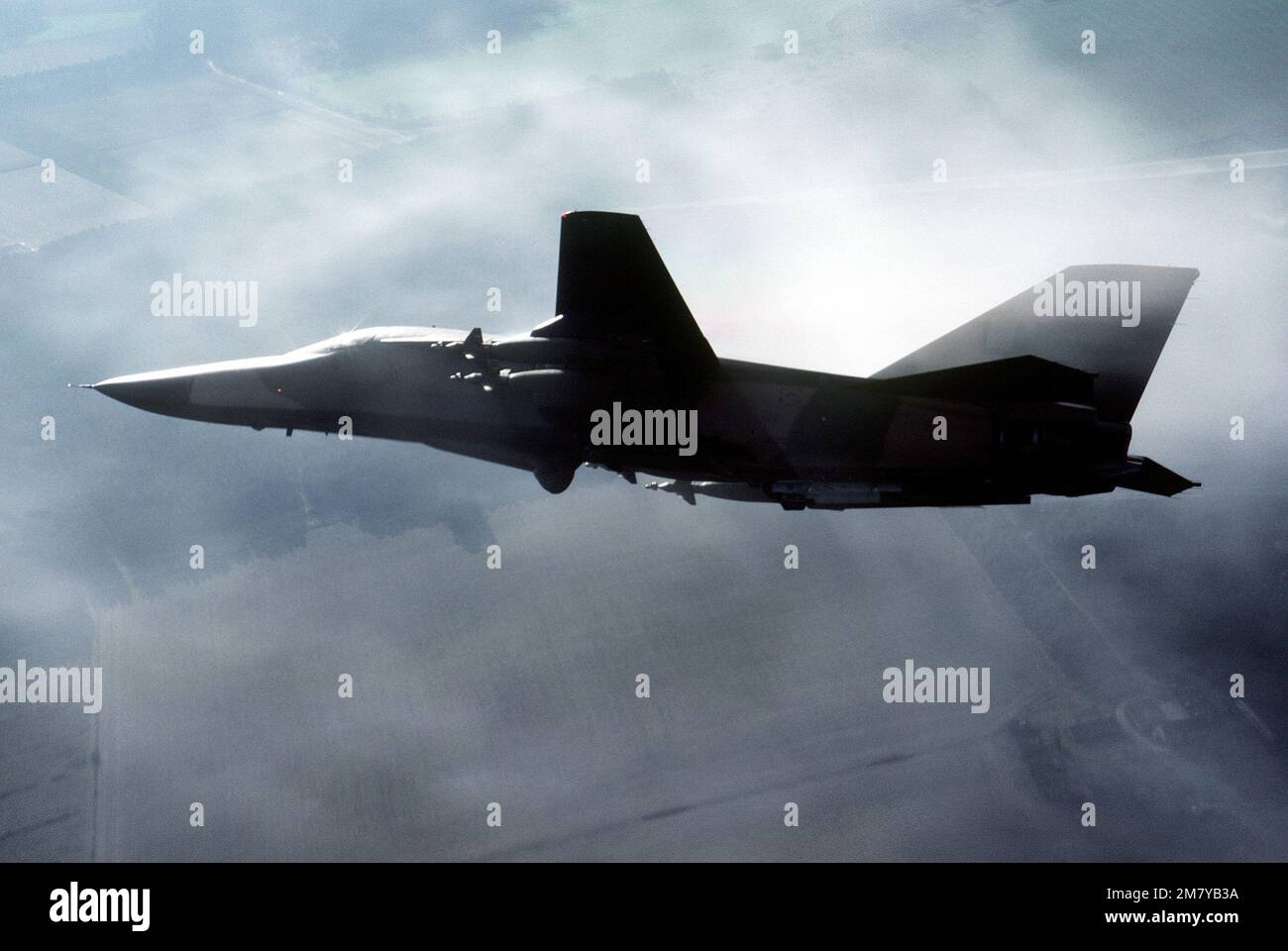 An air-to-air left side view of an F-111 aircraft flown by the 48th ...