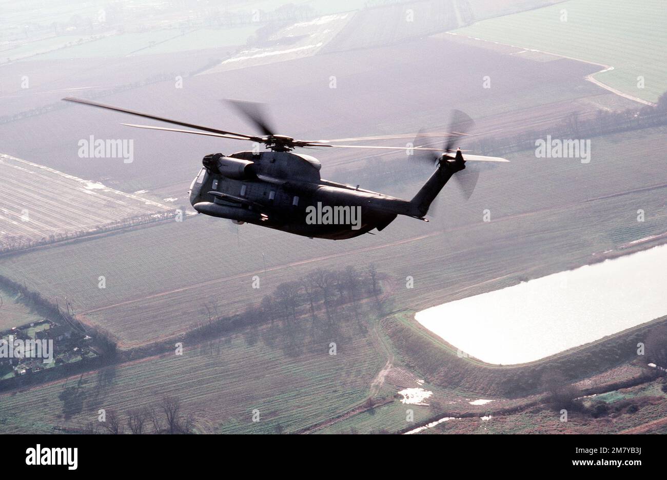 An air-to-air left rear view of an HH-53 Super Jolly helicopter flown ...