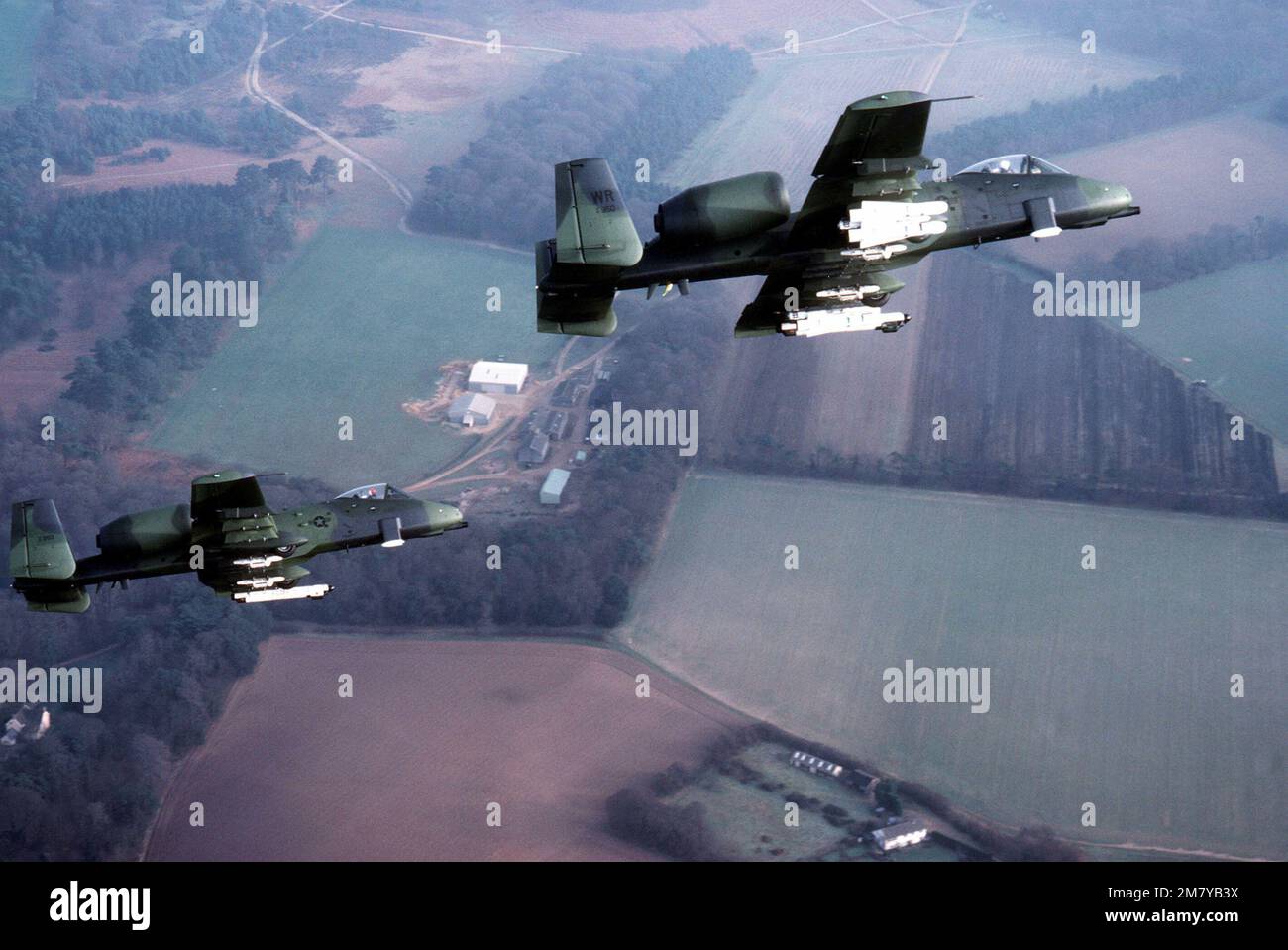 An air-to-air right underside view of two A-10 Thunderbolt II aircraft ...