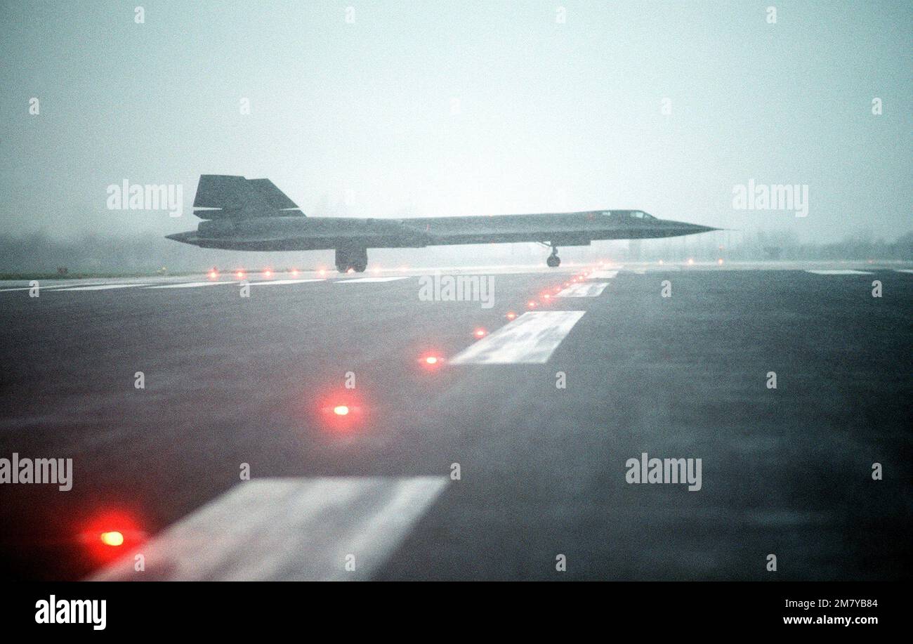A right side view of an SR-71 Blackbird aircraft on a fog-shrouded ...