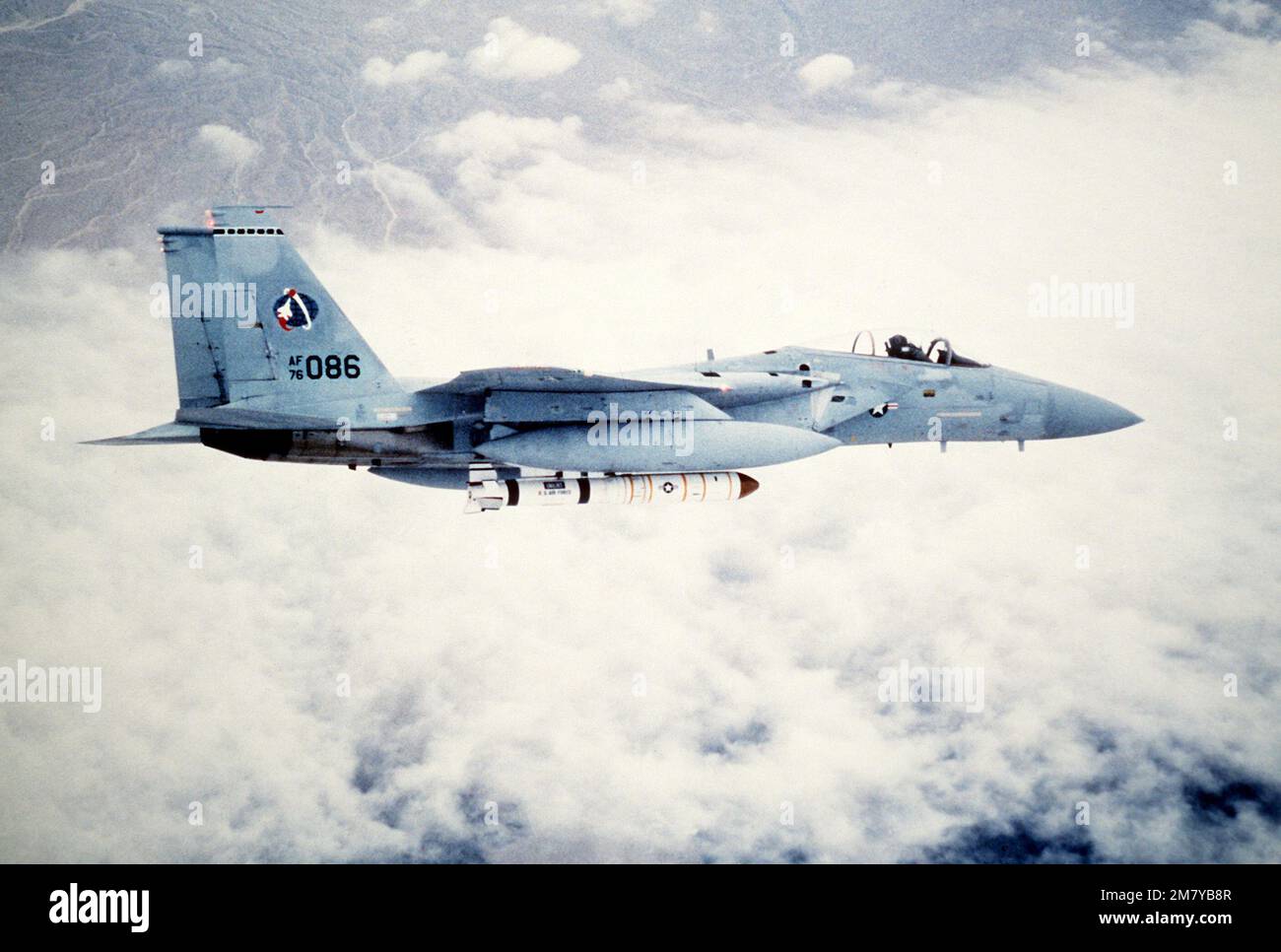 An air-to-air right side view of an F-15 Eagle aircraft carrying an anti-satellite (ASAT ...
