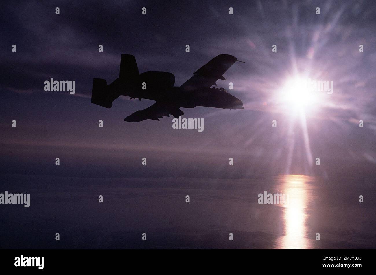 Right underside view of an A-10 Thunderbolt II aircraft silhouetted by ...