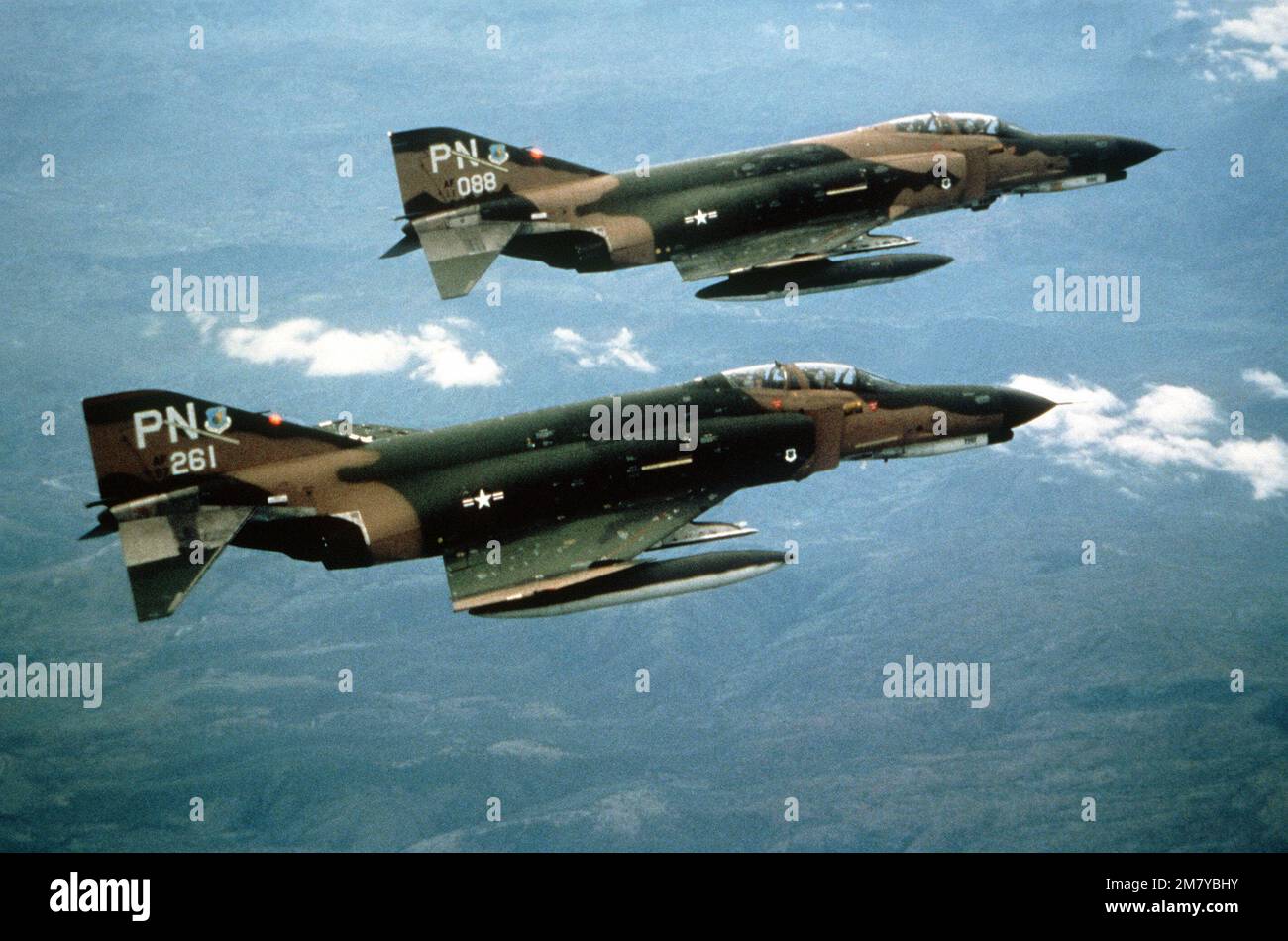 An air-to-air right side view of two F-4E Phantom II aircraft from the ...