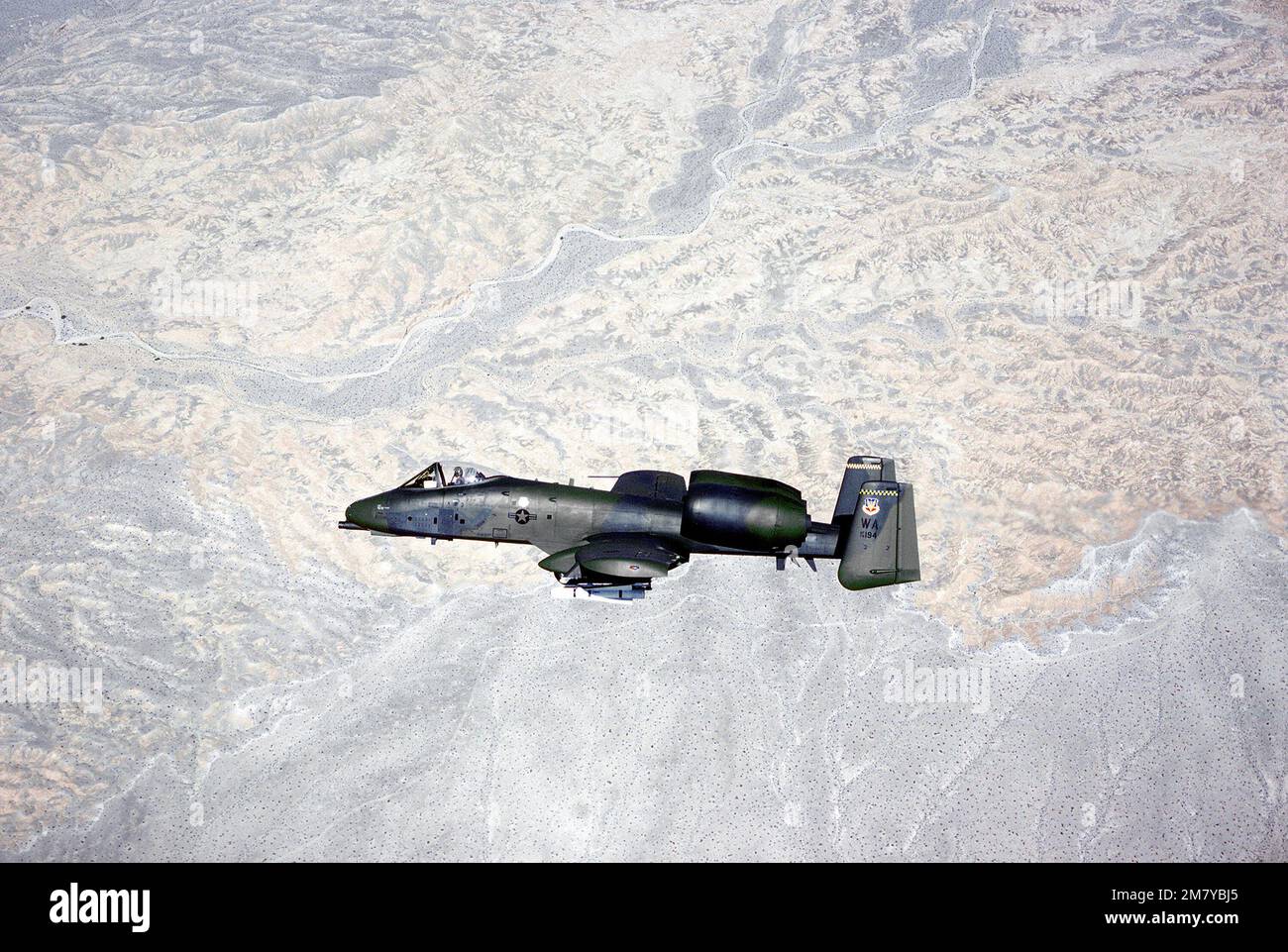 An air-to-air left side view of an A-10 Thunderbolt II aircraft from ...