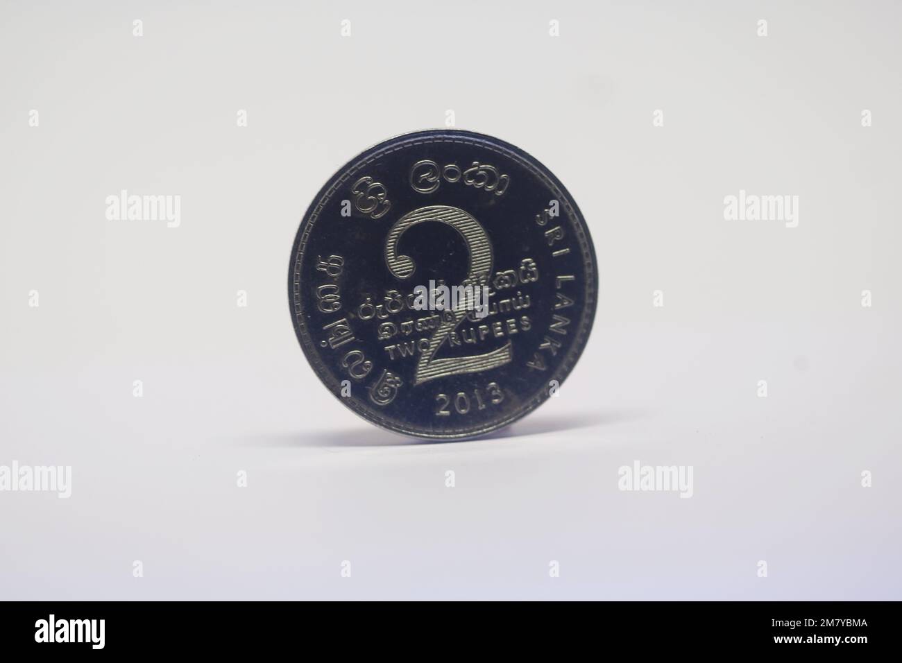 The back of a round shape Sri Lankan two rupee coin isolated on white ...
