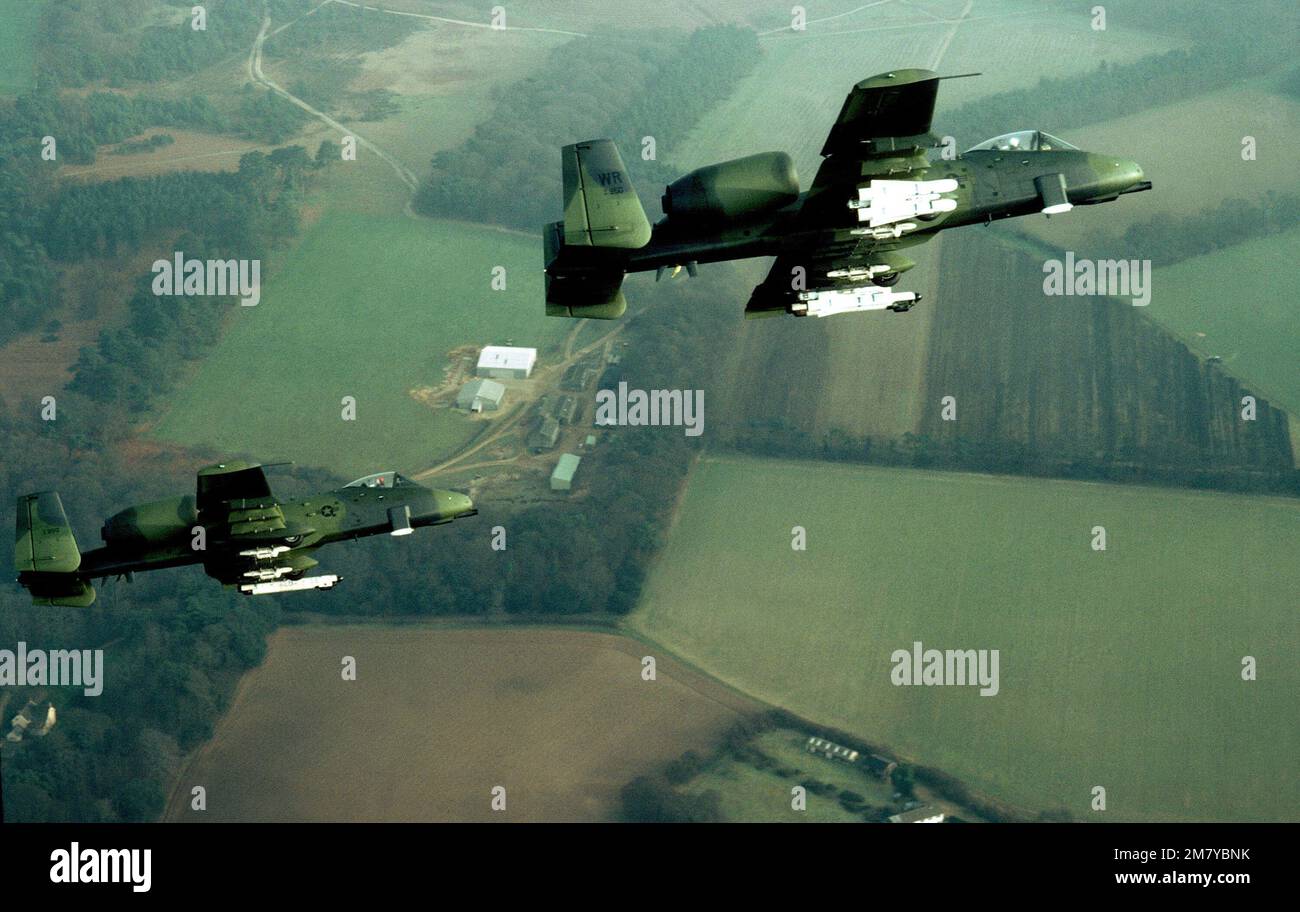 An air-to-air right underside view of two A-10 Thunderbolt II aircraft ...