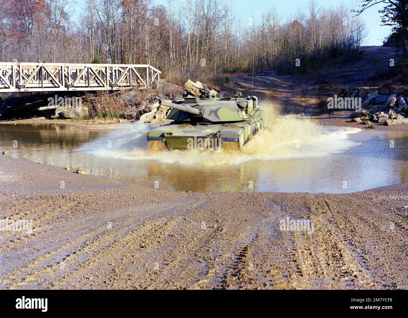An M-1 Abrams main battle tank crosses a shallow river while on ...