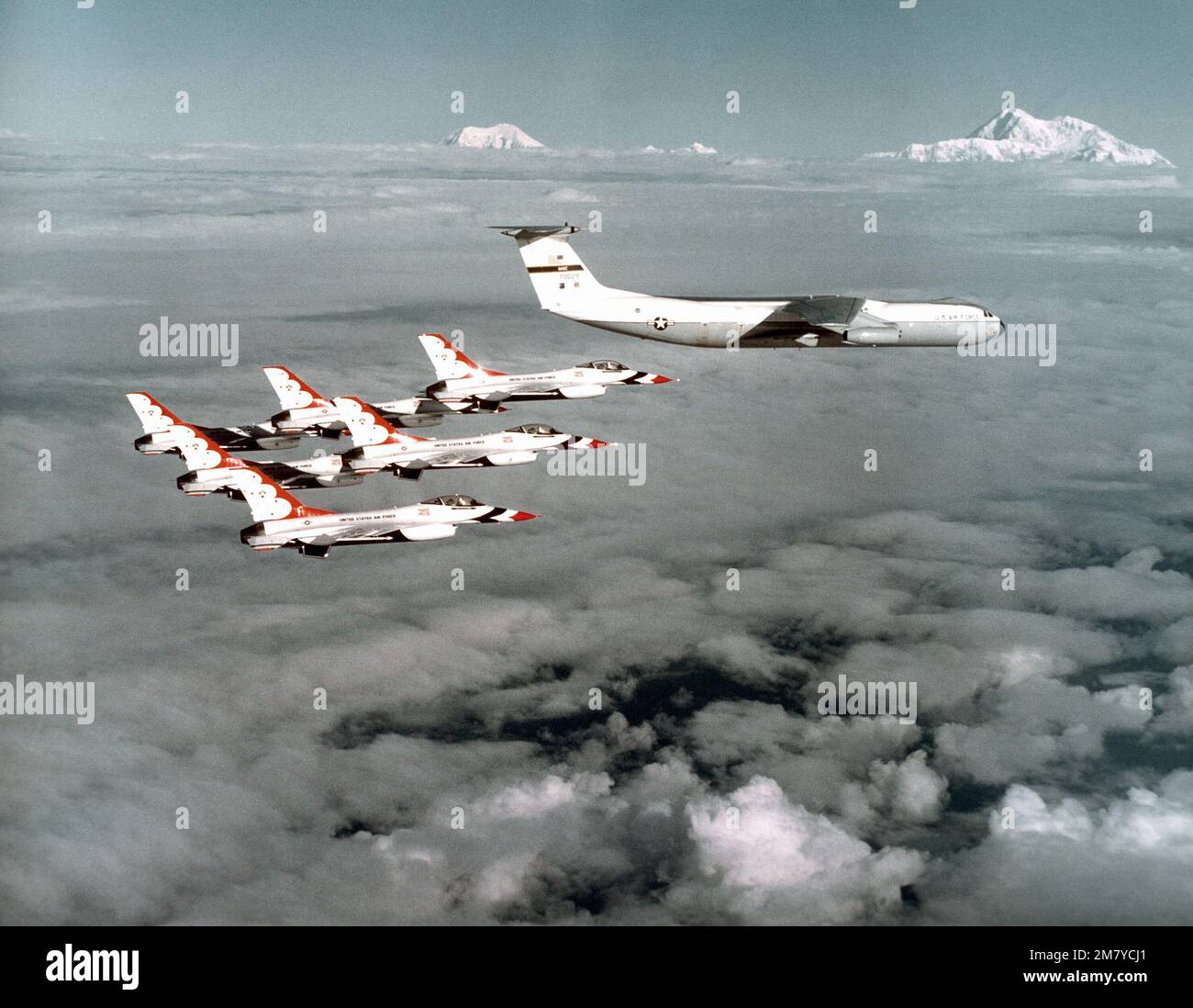 Above the clouds a six-ship Delta formation of Thunderbirds F-16As fly ...