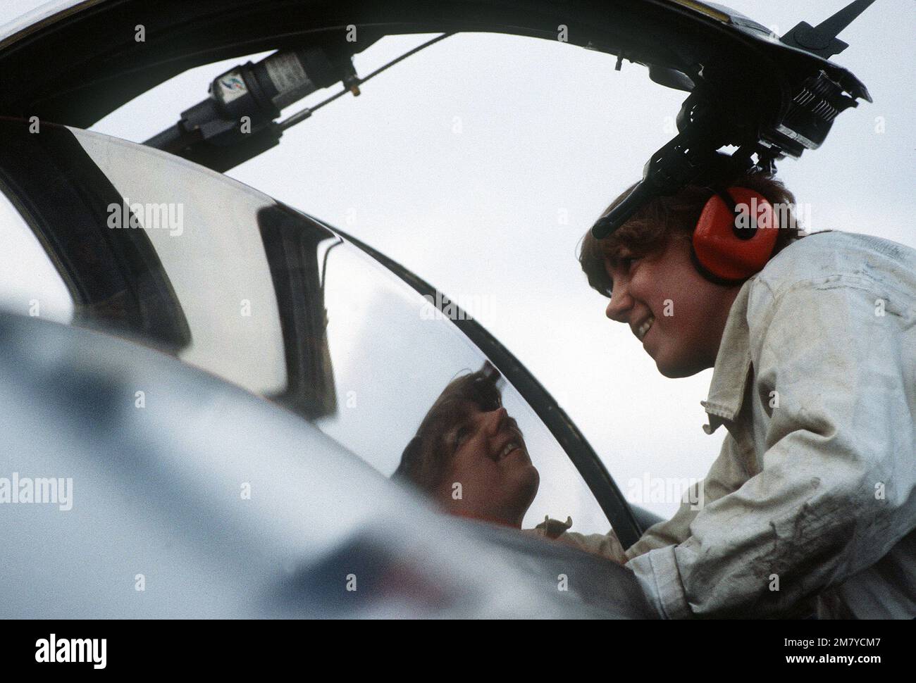 A ground crew chief checks the instrument panel of an F-111A aircraft ...