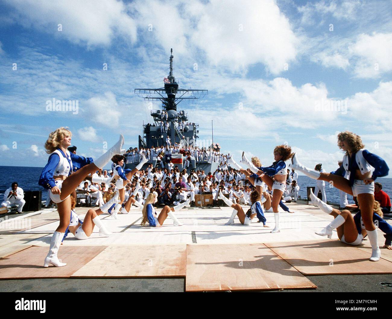 The Dallas Cowboy Cheerleaders perform their USO show "America and Her Music" on the deck of the ...