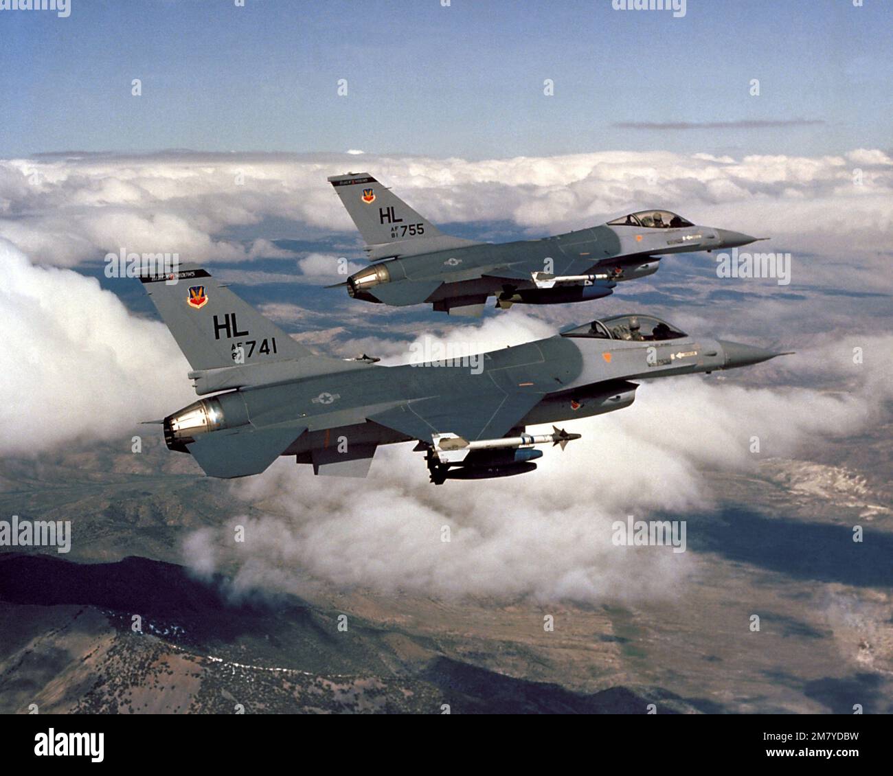 An air-to-air right-side view of two F-16 Fightng Falcon aircraft in ...