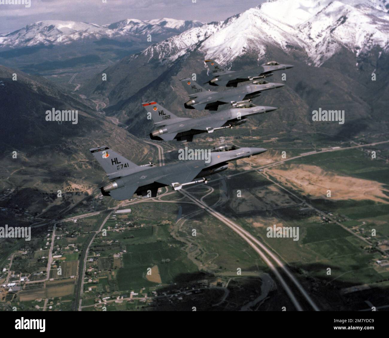An air-to-air right-side view of four F-16 Fightng Falcon aircraft in ...