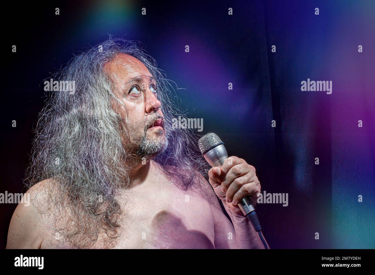 Passionate and eccentric rock senior male with piercing in the nose and ...