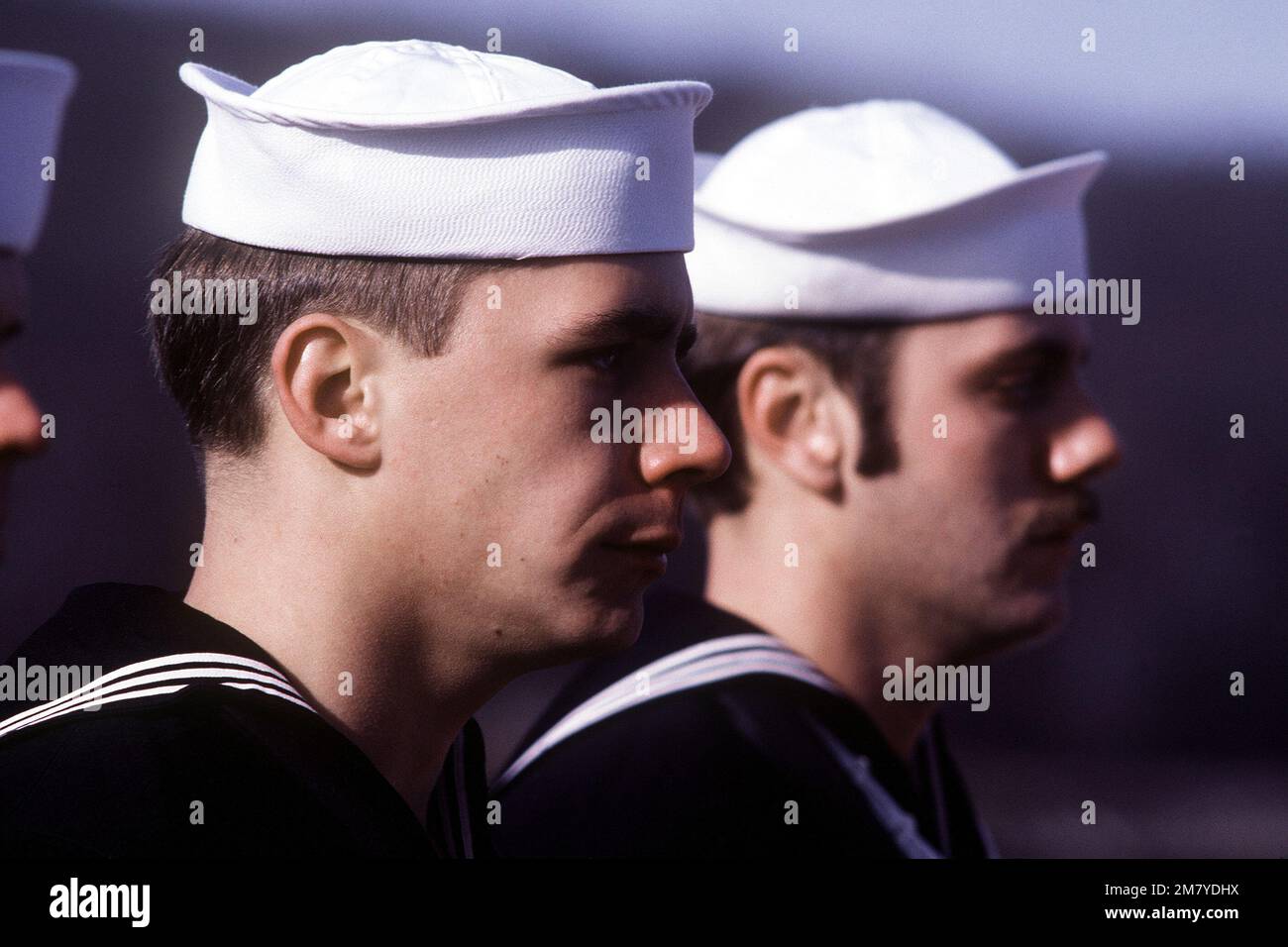 Two crewmen stand at attention during the commissioning ceremonies for ...