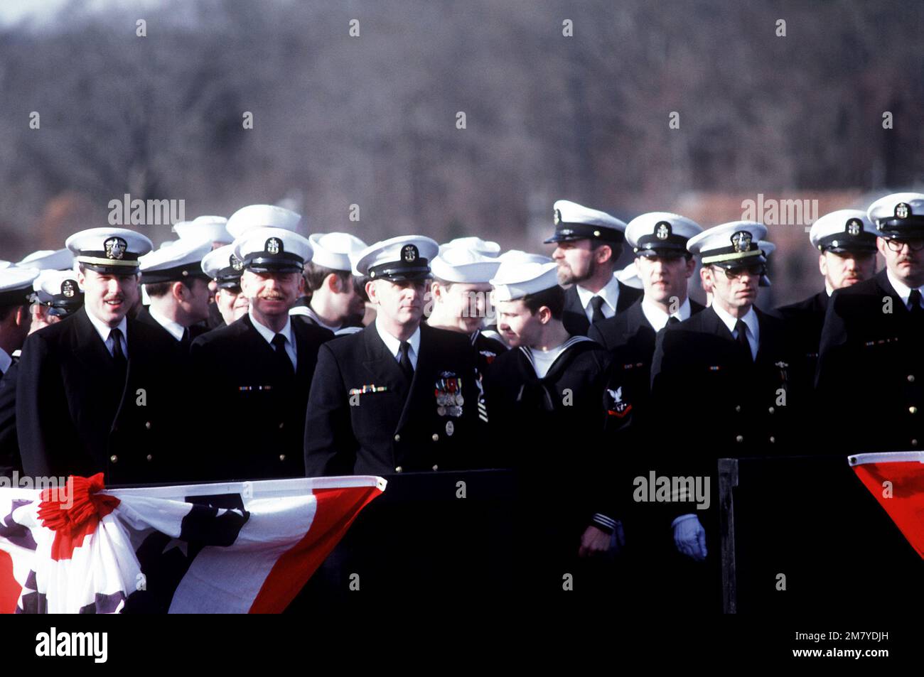 Crewmen stand in formation aboard the nuclear-powered attack submarine ...
