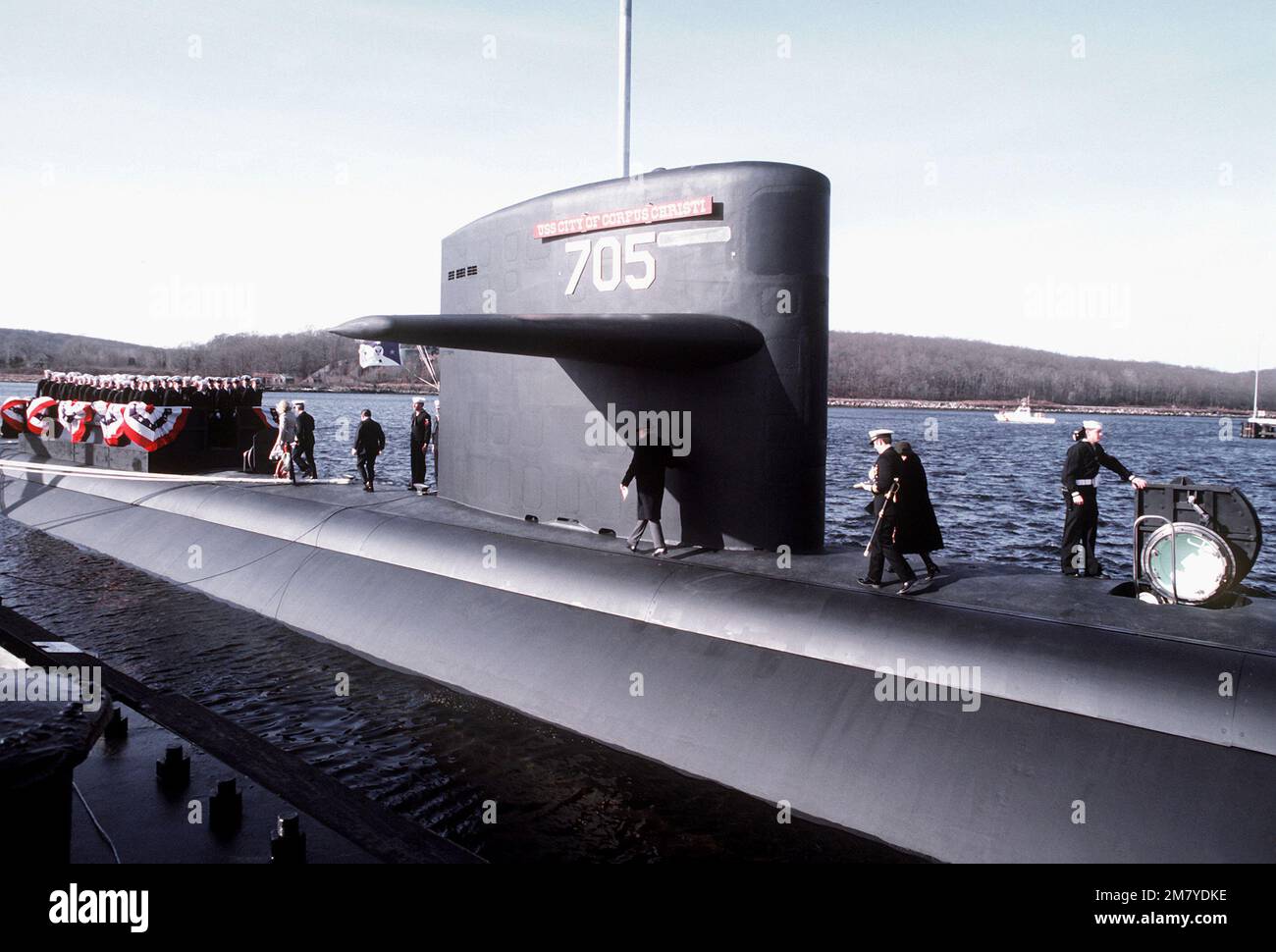 Crewmen stand in formation as distinguished guests are escorted on a ...