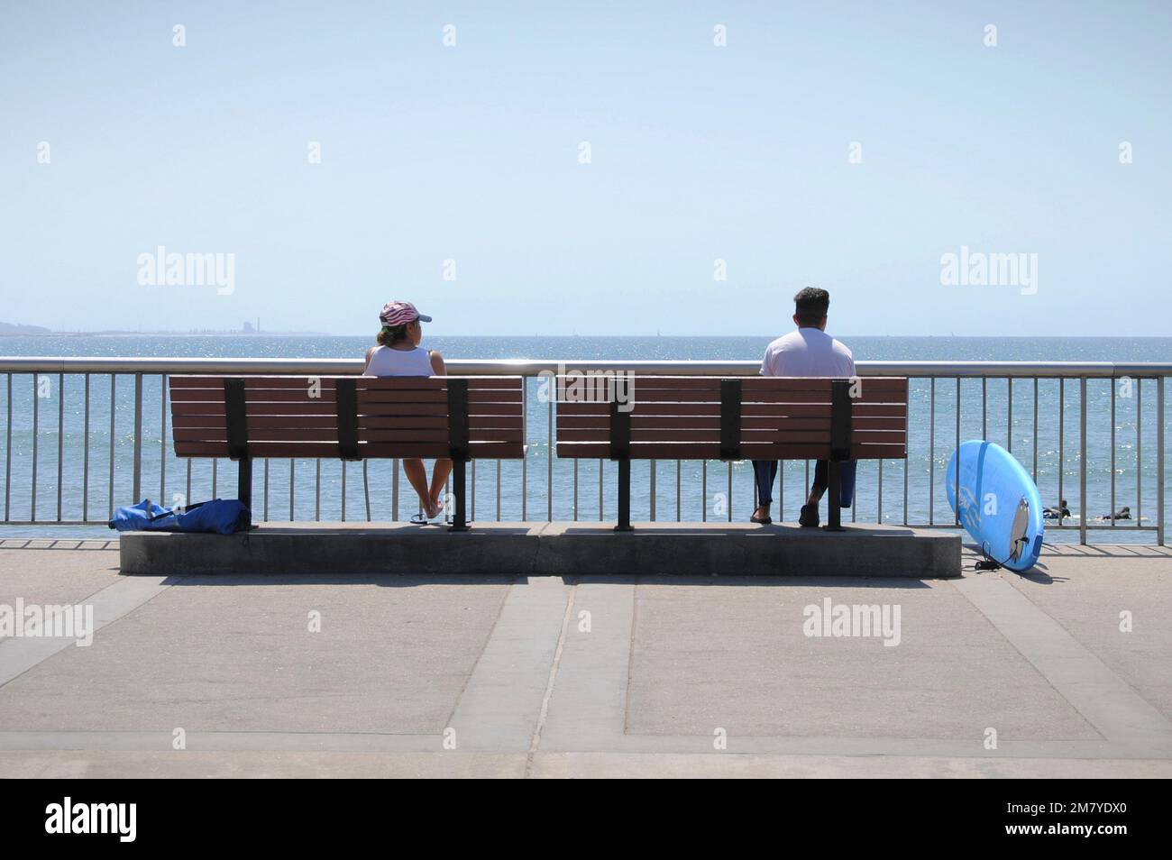 Back view of two people sitting on a bench Stock Photo - Alamy
