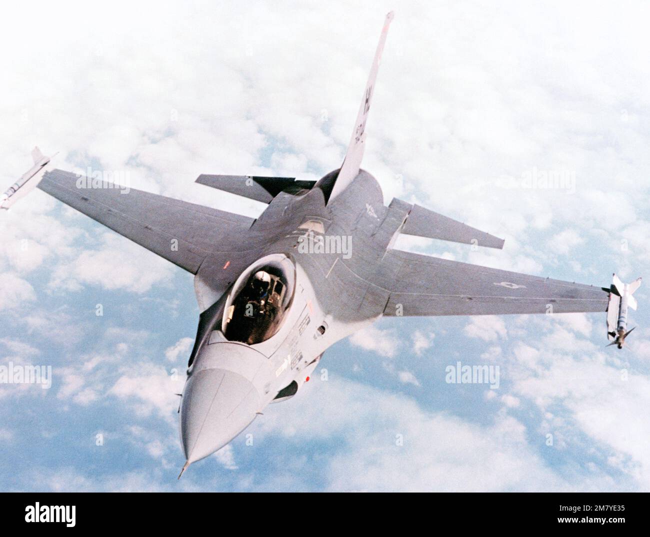 A high angle air-to-air front view of an F-16A Fighting Falcon aircraft ...