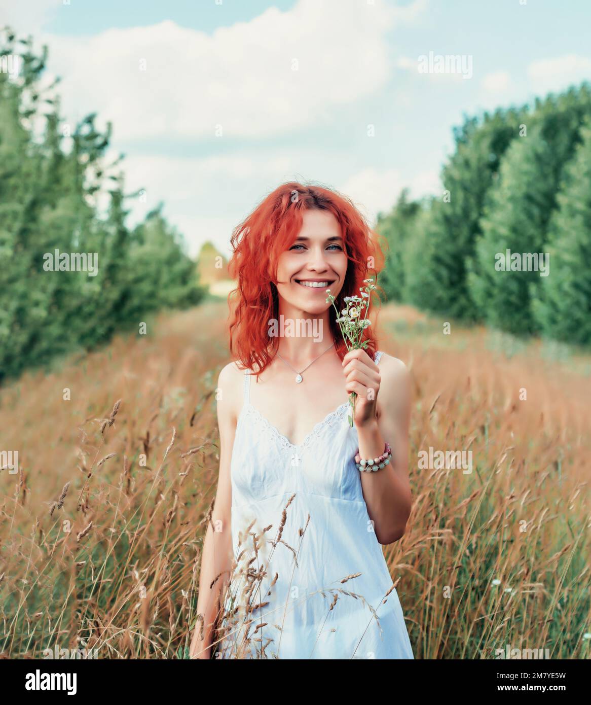 Red woman among dry grass in garden Stock Photo - Alamy