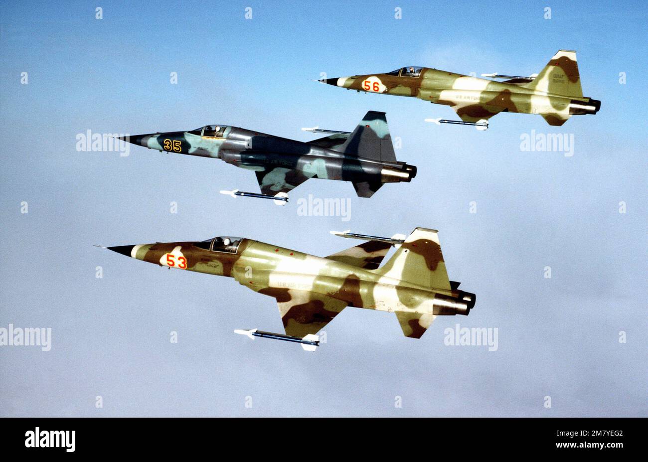 An air-to-air left side view of three F-5E Tiger II aircraft from the ...