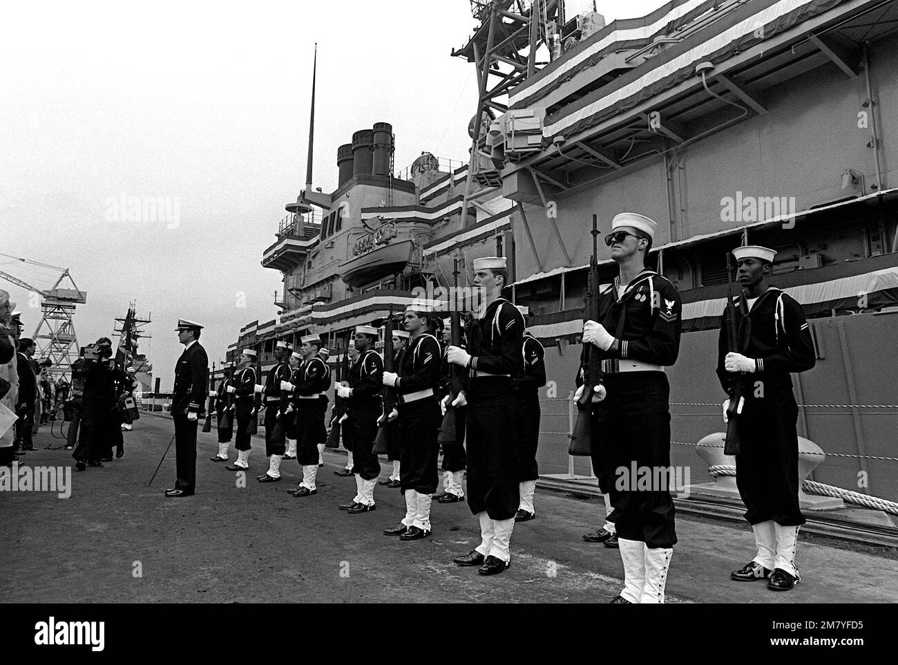 An honor guard stands at the present arms position during commissioning ...