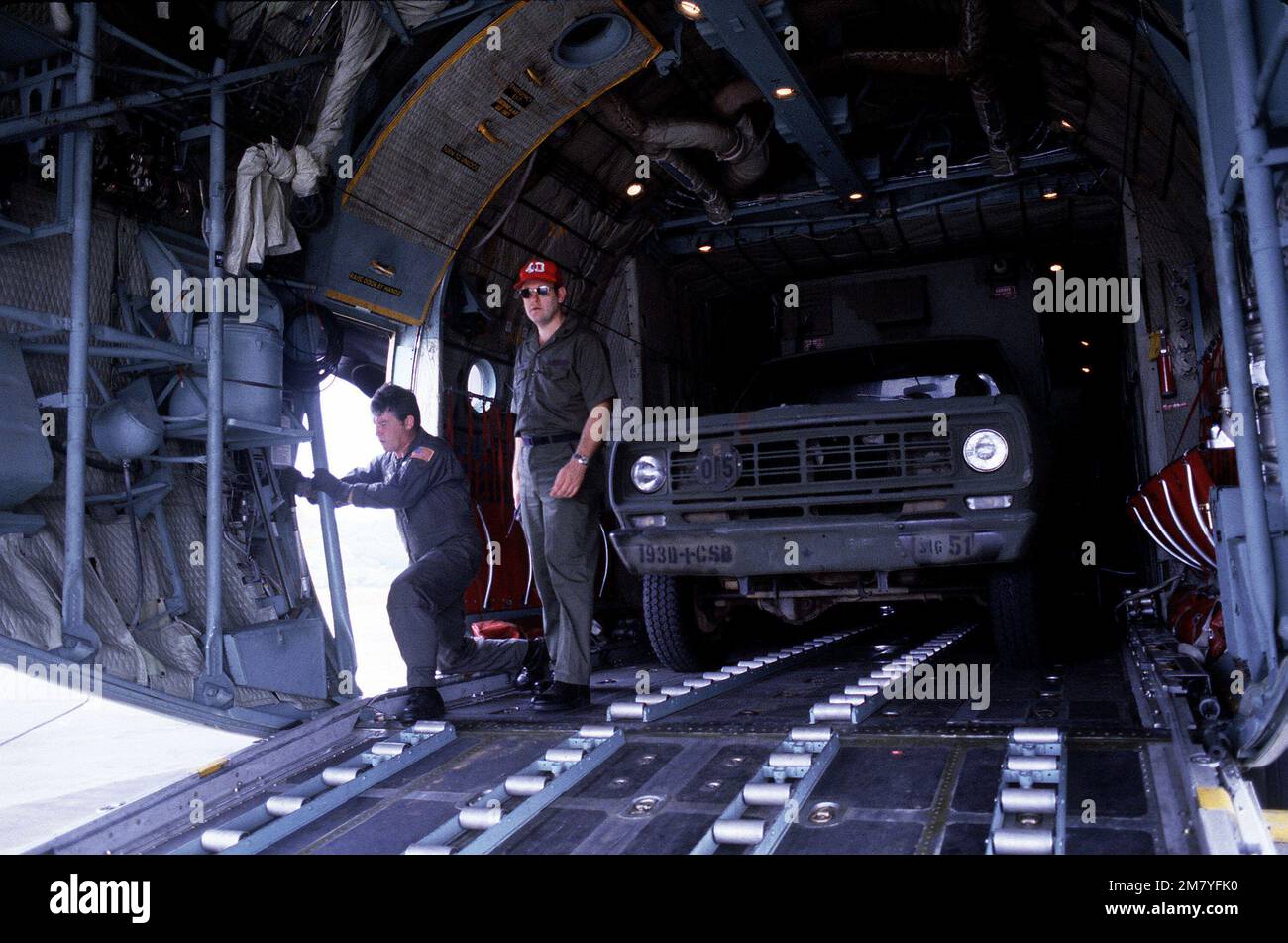 A truck is loaded into the cargo bay of a Military Airlift Command C ...