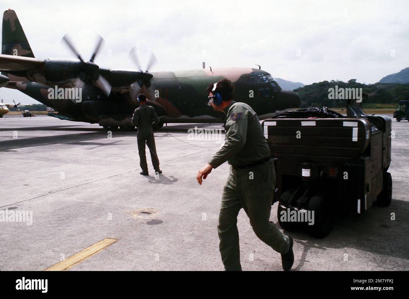 A C-130 Hercules aircraft starts its engines. A C-130 is making a ...