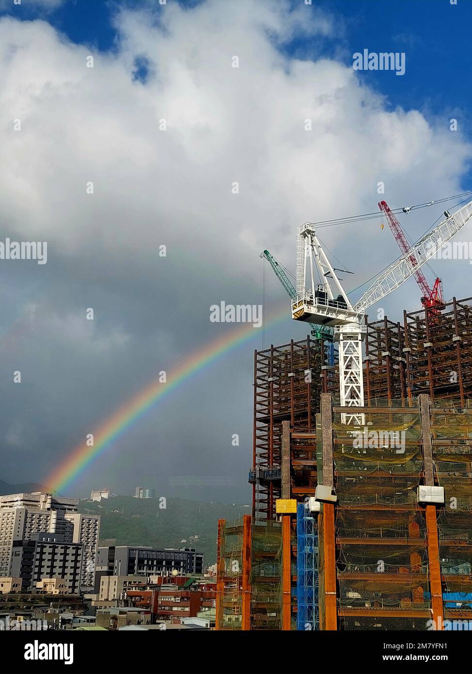 Rainbow over building under construction in Taipei Stock Photo - Alamy