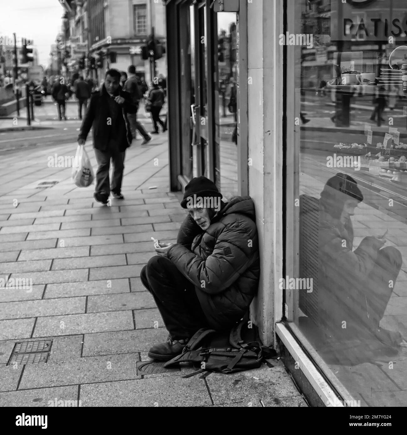 Sitting beggar Black and White Stock Photos & Images - Alamy