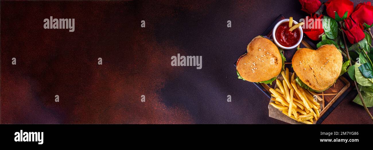 Valentine day Heart-shaped burgers. Two tasty cheeseburgers with french ...