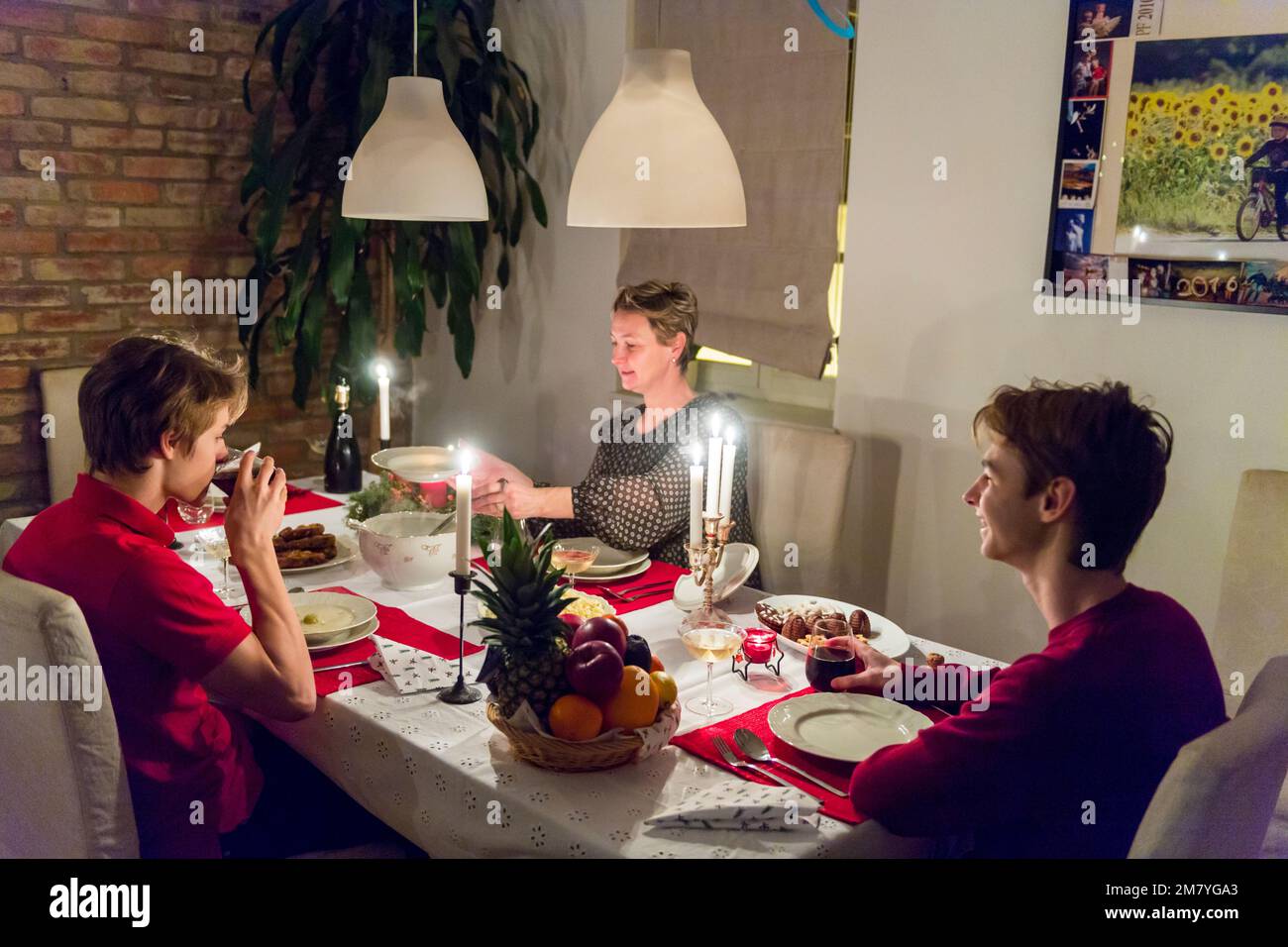 family of three at the set table at home Stock Photo - Alamy
