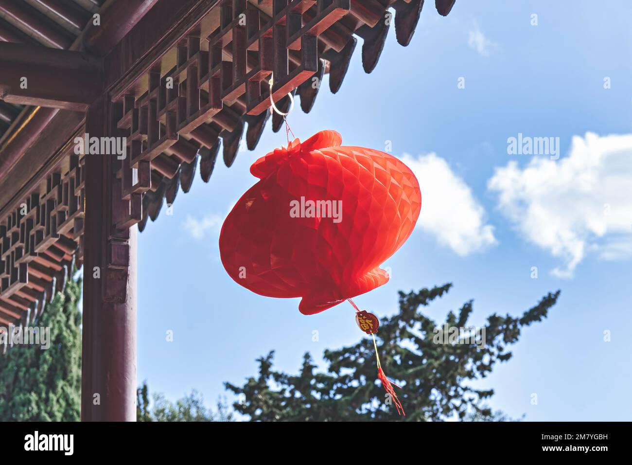 Red china lantern hanging on traditional chinese roof during ...