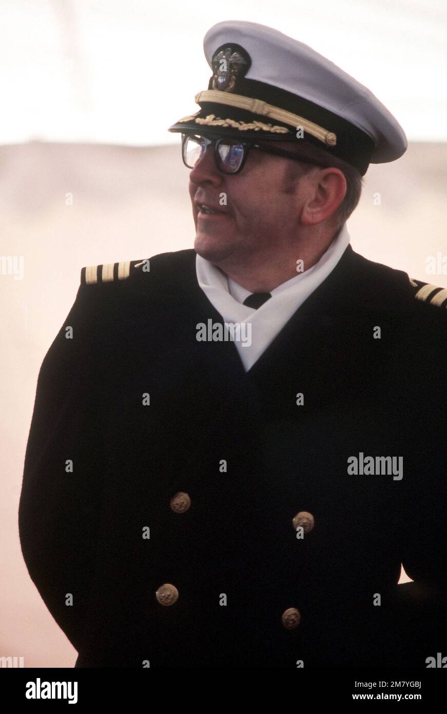 An officer arrives to observe the commissioning ceremony for the guided ...
