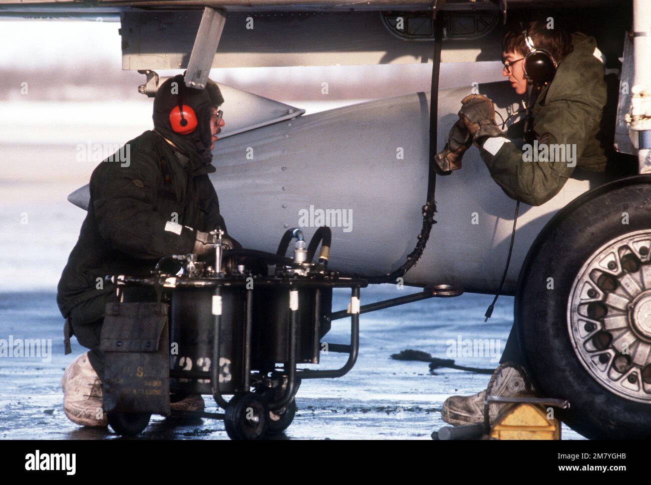 Members of the 43rd Tactical Fighter Squadron fill the hydraulic system ...