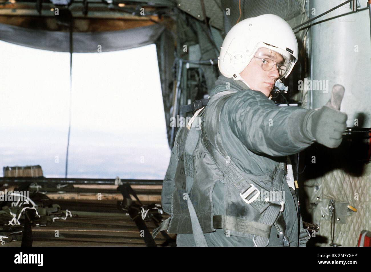 A crewman gives the "Thumbs Up" sign as he prepares to conduct a Low ...