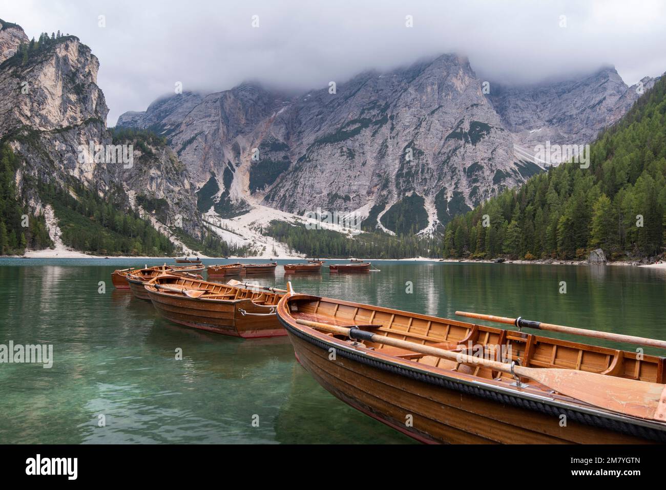 Wooden rowing boats for hire on Lago di Braies in the Dolomites, Italy ...