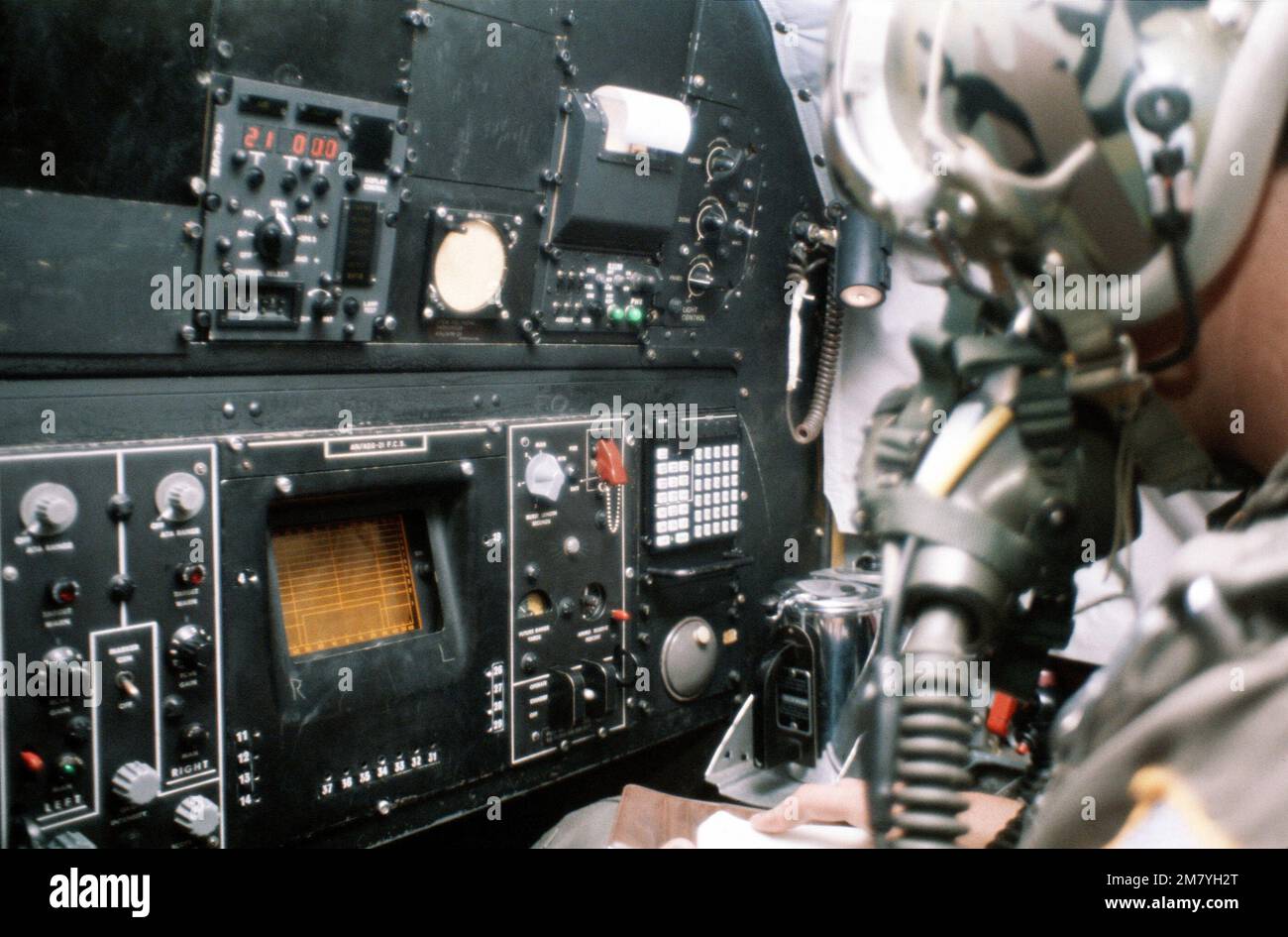 Technical Sergeant Ben De Hoyos, gunner, programs a console aboard a B ...