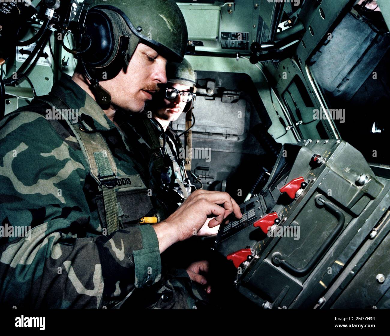 A multiple launch rocket system (MLRS) gunner operates the fire control ...