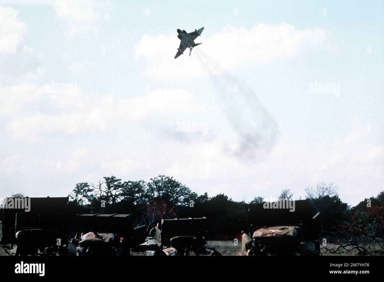 A ground-to-air view of an F-4 Phantom II aircraft as it makes a low ...