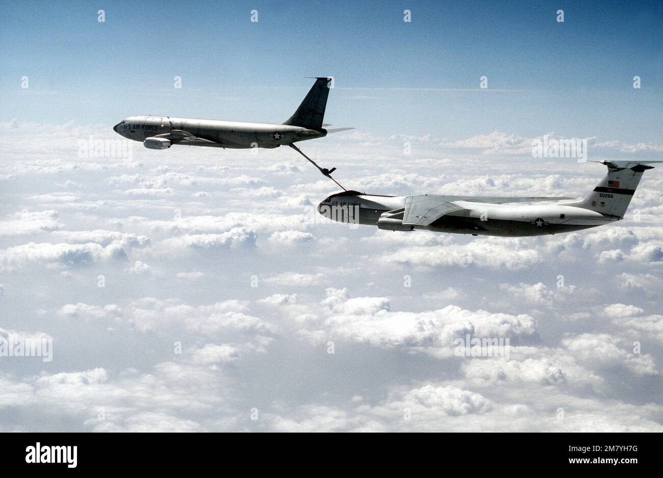 An air-to-air left side view of a KC-135A Stratotanker aircraft from ...